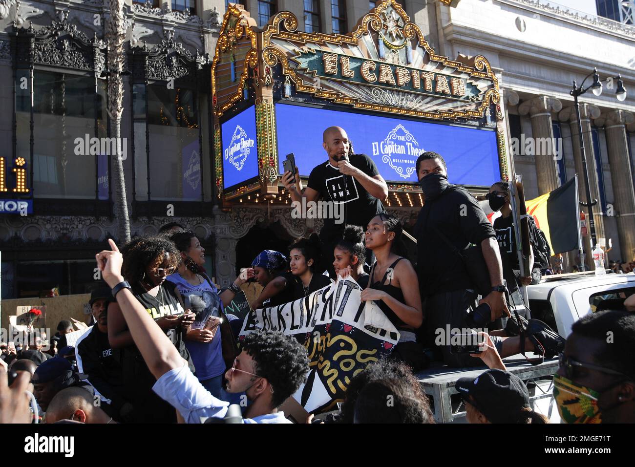 Demonstrators march past the El Capitan theater Sunday June, 7, 2020 in ...