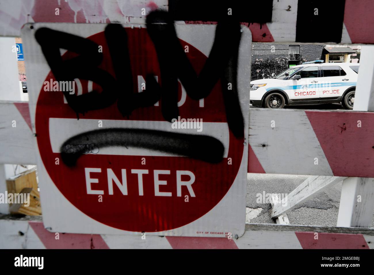 A Chicago Police vehicle parks behind a do not enter sign barricade ...