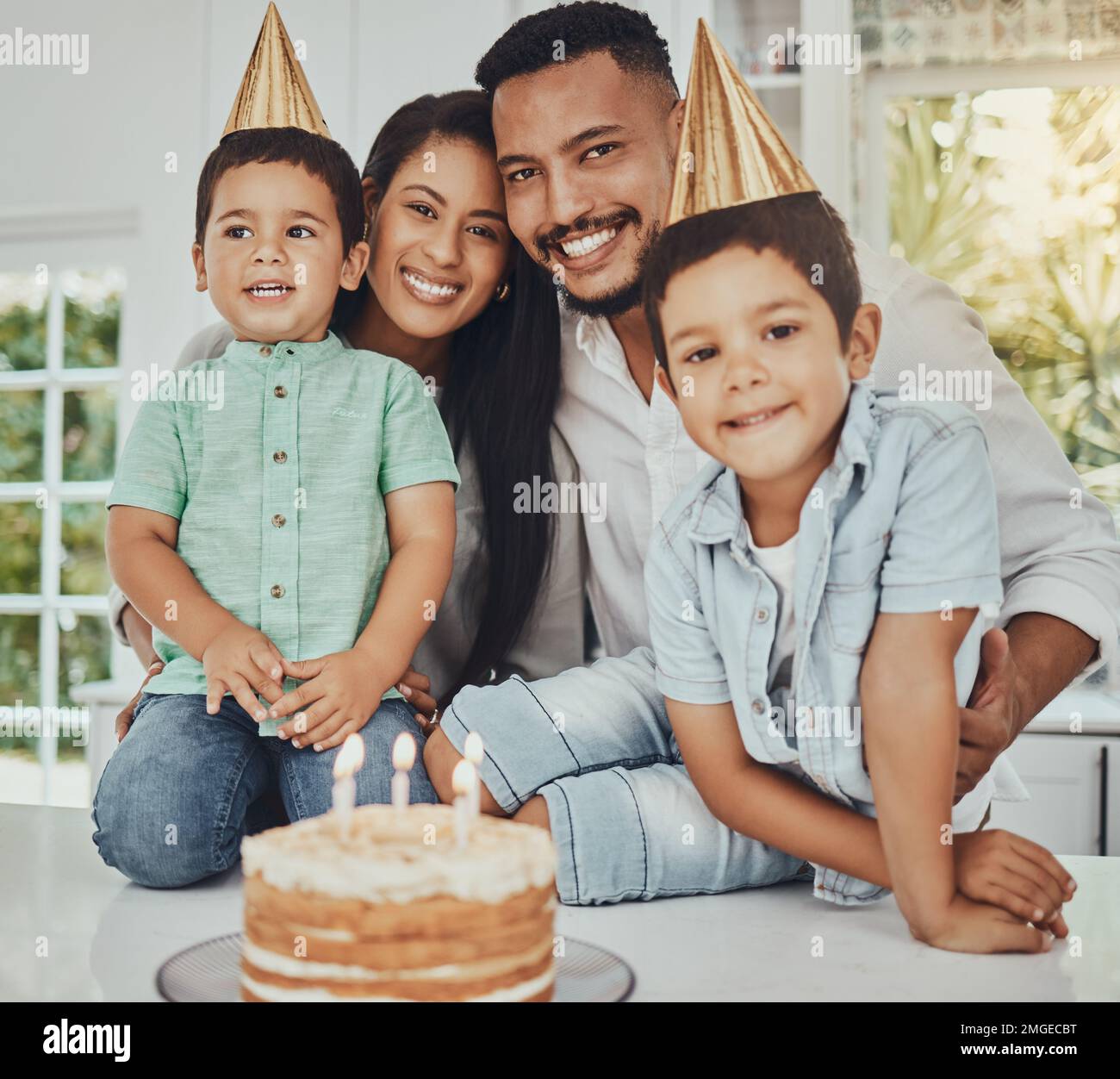 Birthday, portrait and children with parents in a kitchen for cake ...