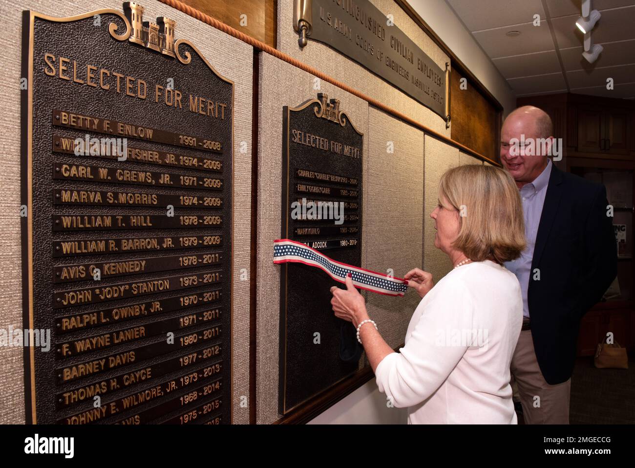 Retiree Linda Adcock and her husband Ricky unveil her nameplate during ...