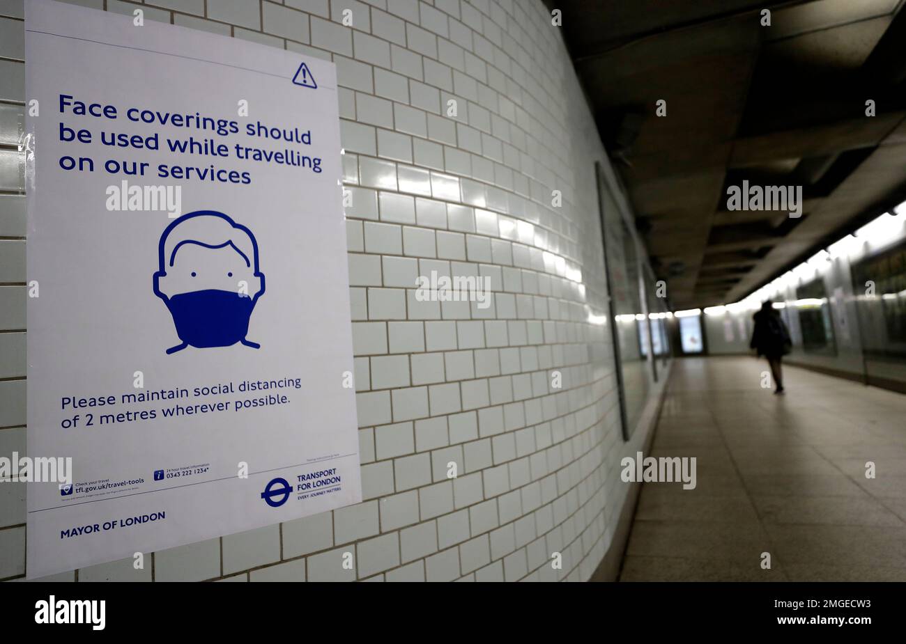 A sign advises travellers to wear face coverings at Westminster Station ...