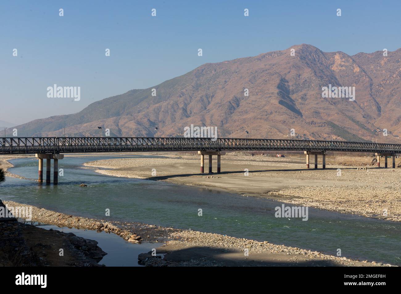 Beautiful view of modular steel bridge over a flowing river with ...