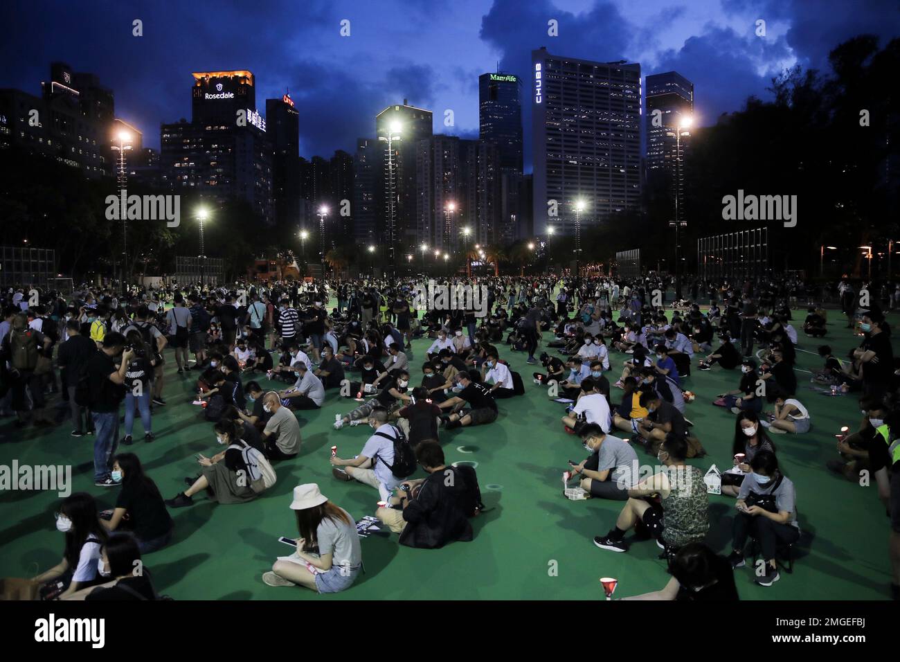 Participants hold candles as they gather for a vigil to remember the ...