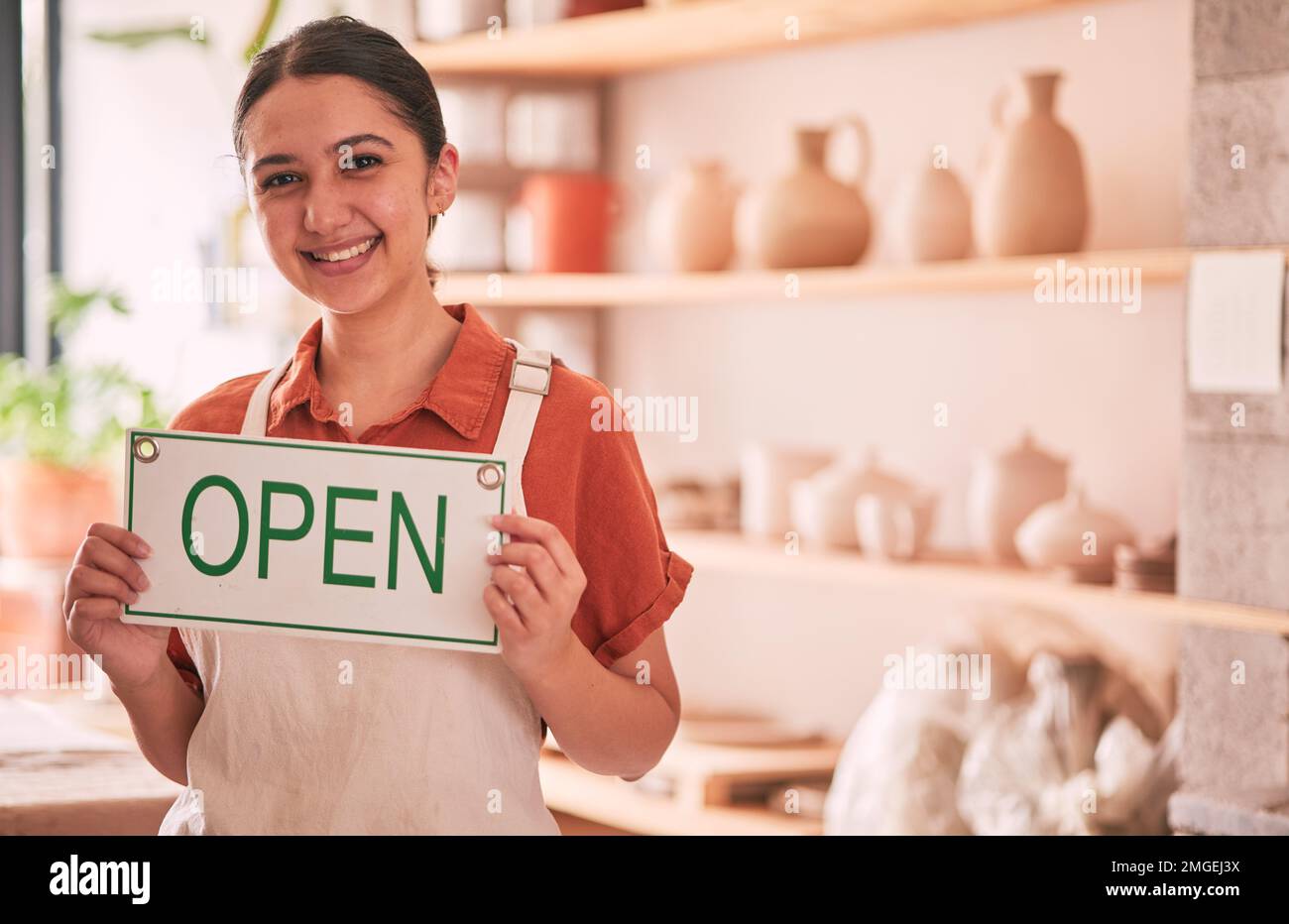 Woman, pottery art and small business with open sign for creative ...