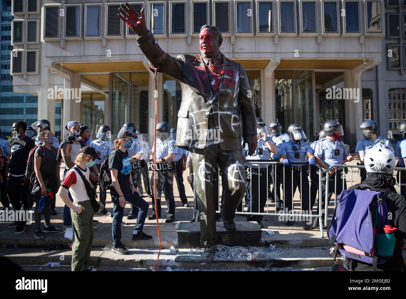 In this Saturday, May 30, 2020 photo police stand near a vandalized statue of controversial ...
