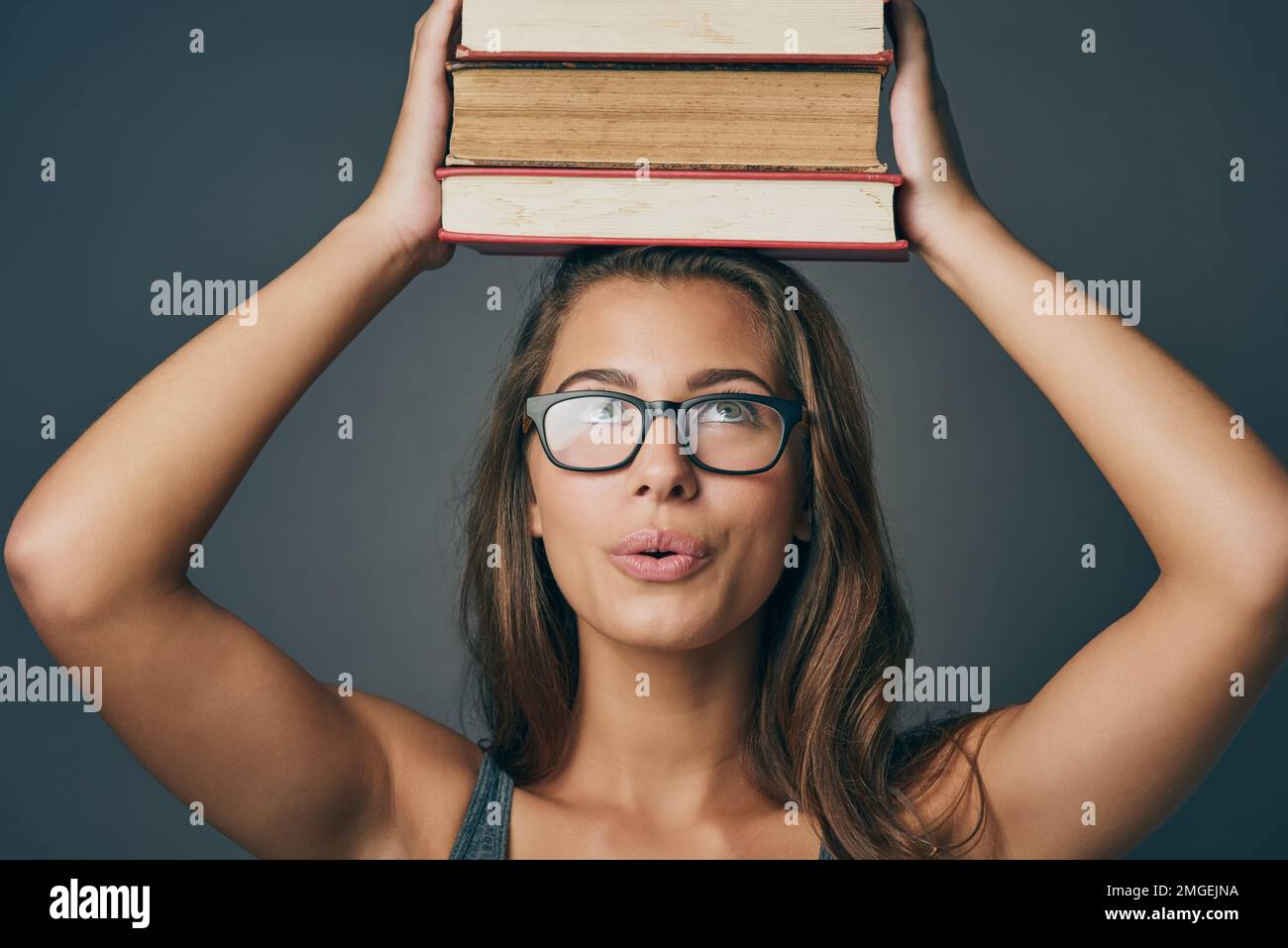 Beautiful female posing books standing hi-res stock photography and ...