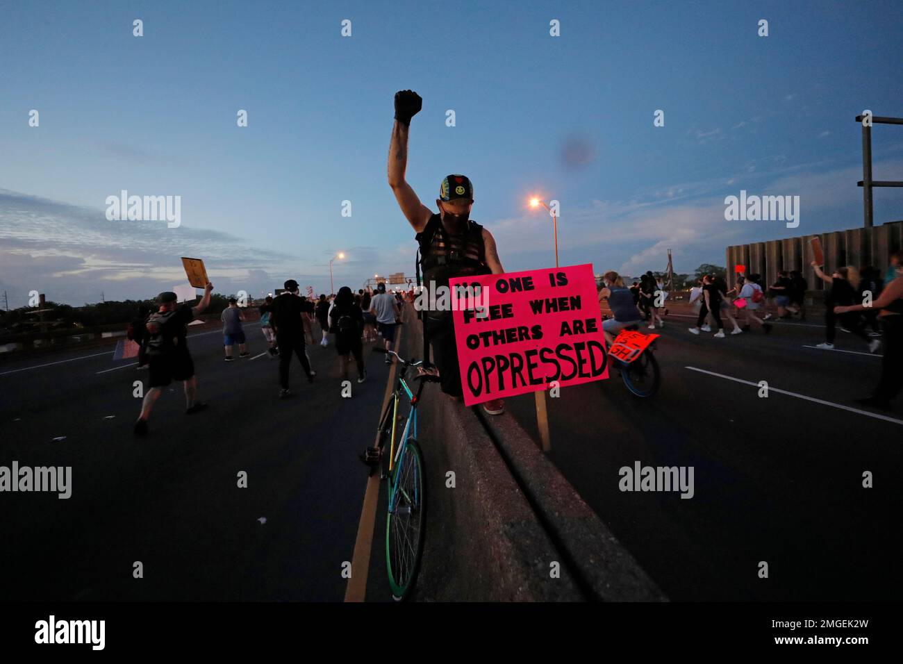 Protesters take over the elevated Interstate 10 during a march in New ...