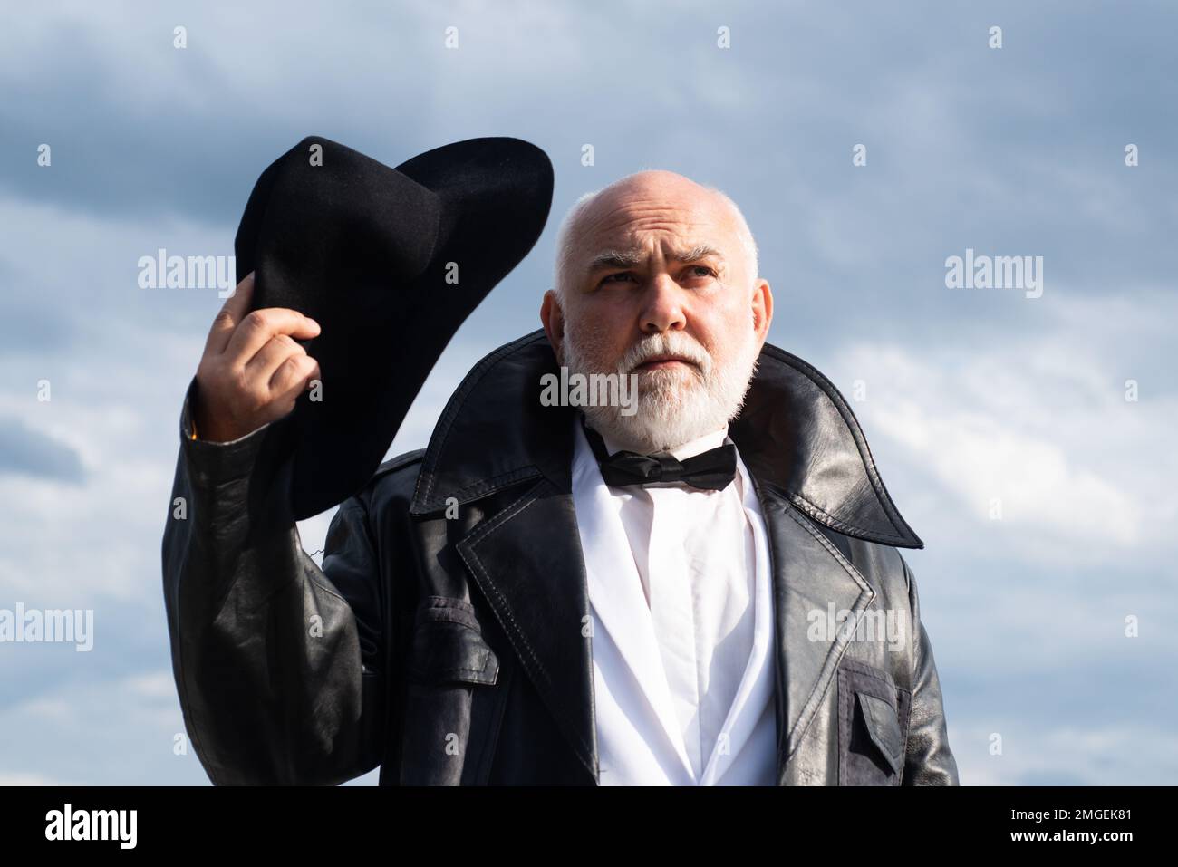 Fashion man in leather coat. Cool gray bearded male confidently posing ...