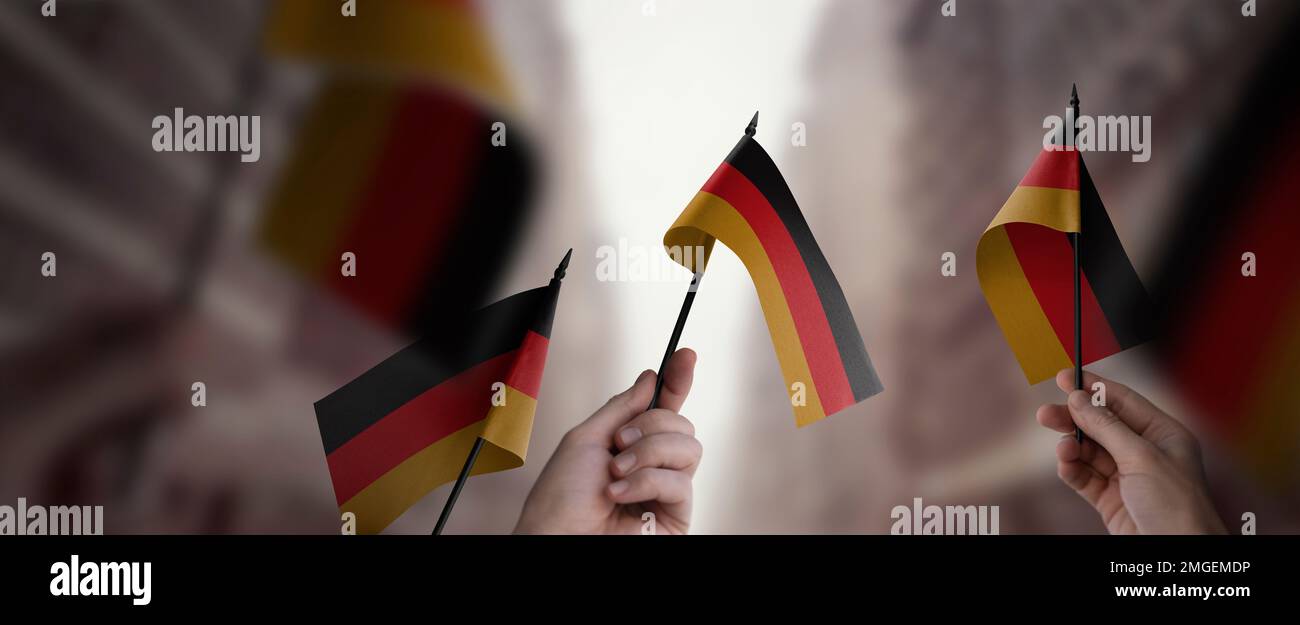 A group of people holding small flags of the Germany in their hands ...