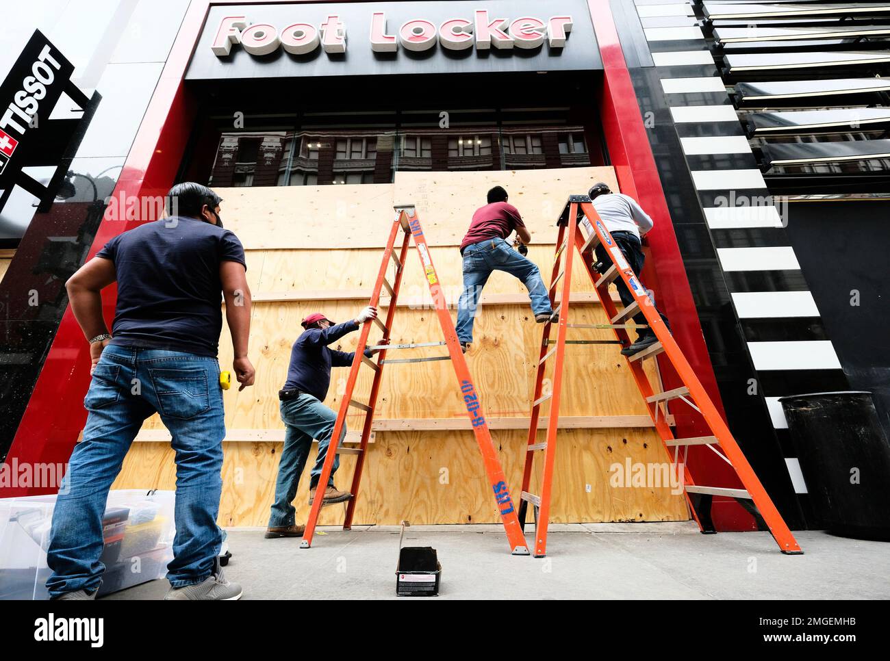 A Foot Locker store on 34th Street being boarded up after a night of ...