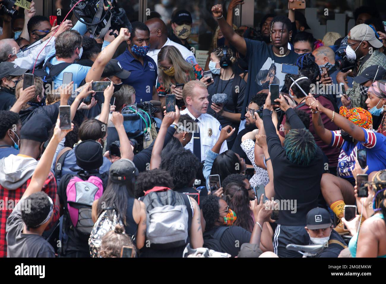 Richmond Police Chief William Smith, center, takes a knee along with ...