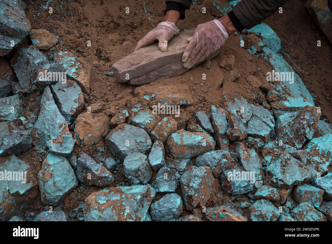 A relative uses rocks to decorate the tomb of Adrian Tarazona Manrique ...