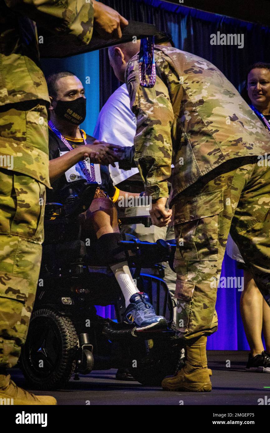 U.S. Army Capt. Luis Avila receives a gold medal for seated shot put ...