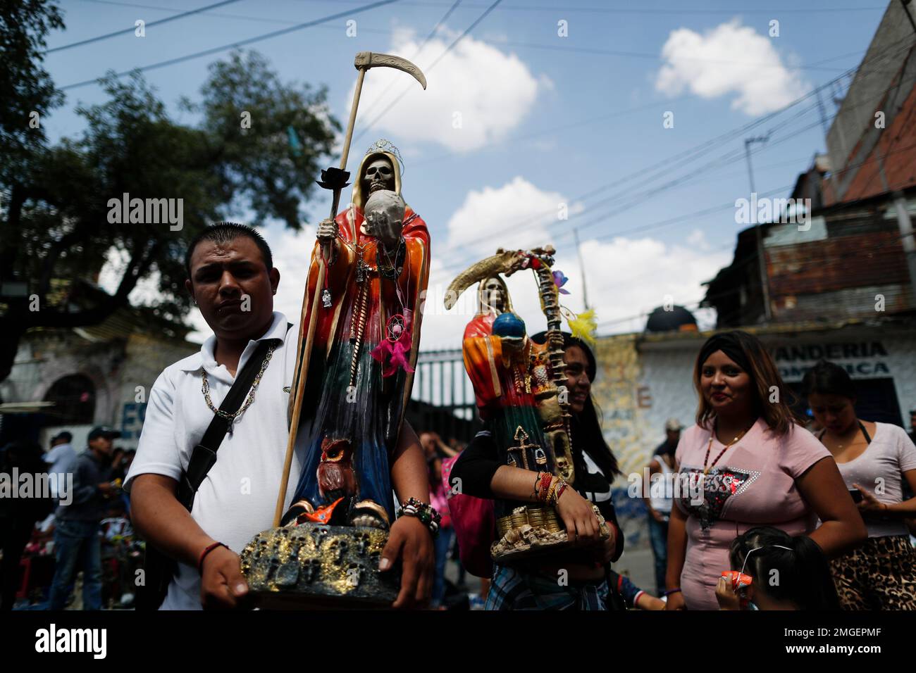 Devotees carry statues of the "Santa Muerte," or Death Saint, as they ...