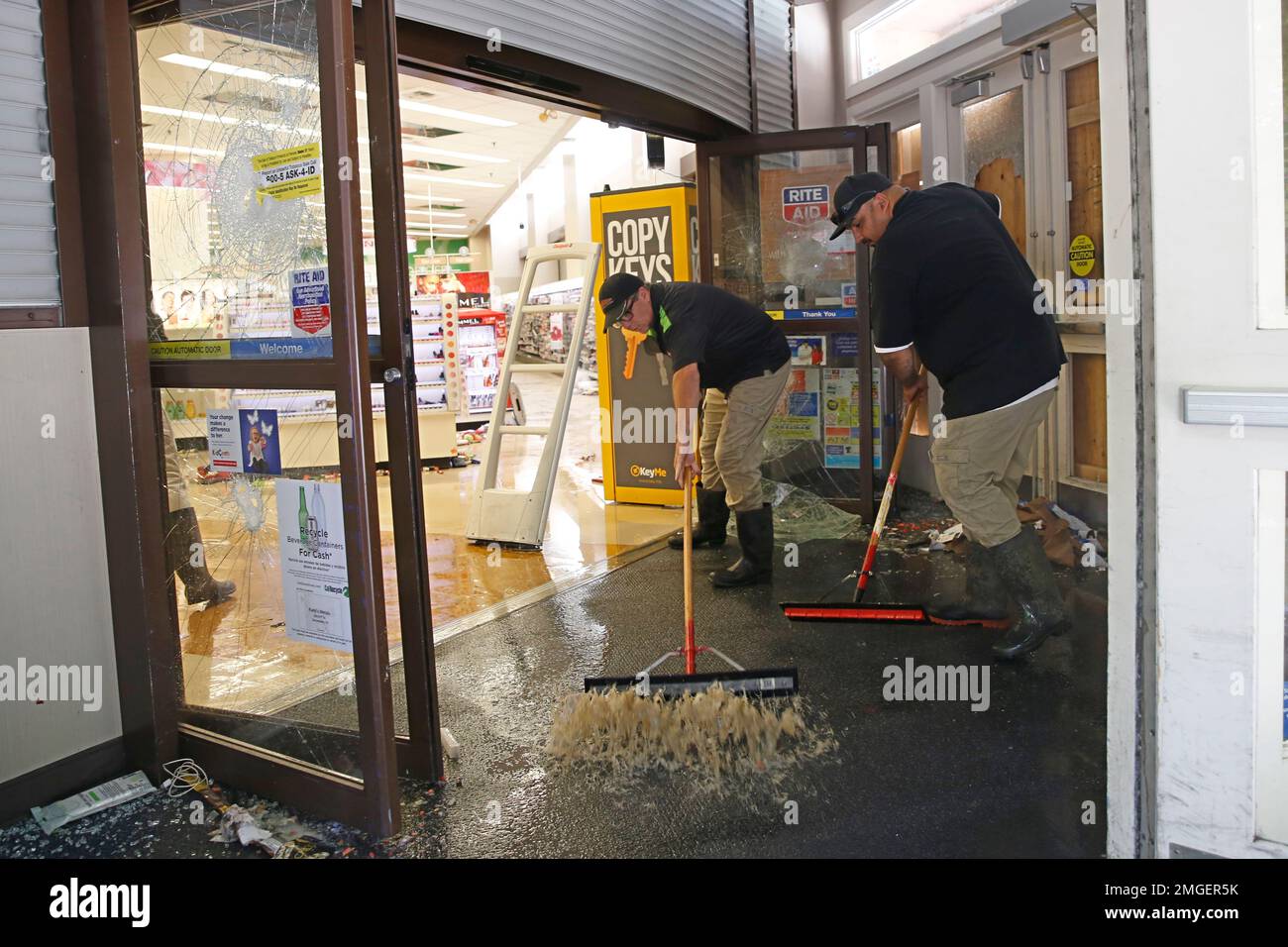 Mark Meddings, left, and Alan Sargent, right, push water out of a Rite ...