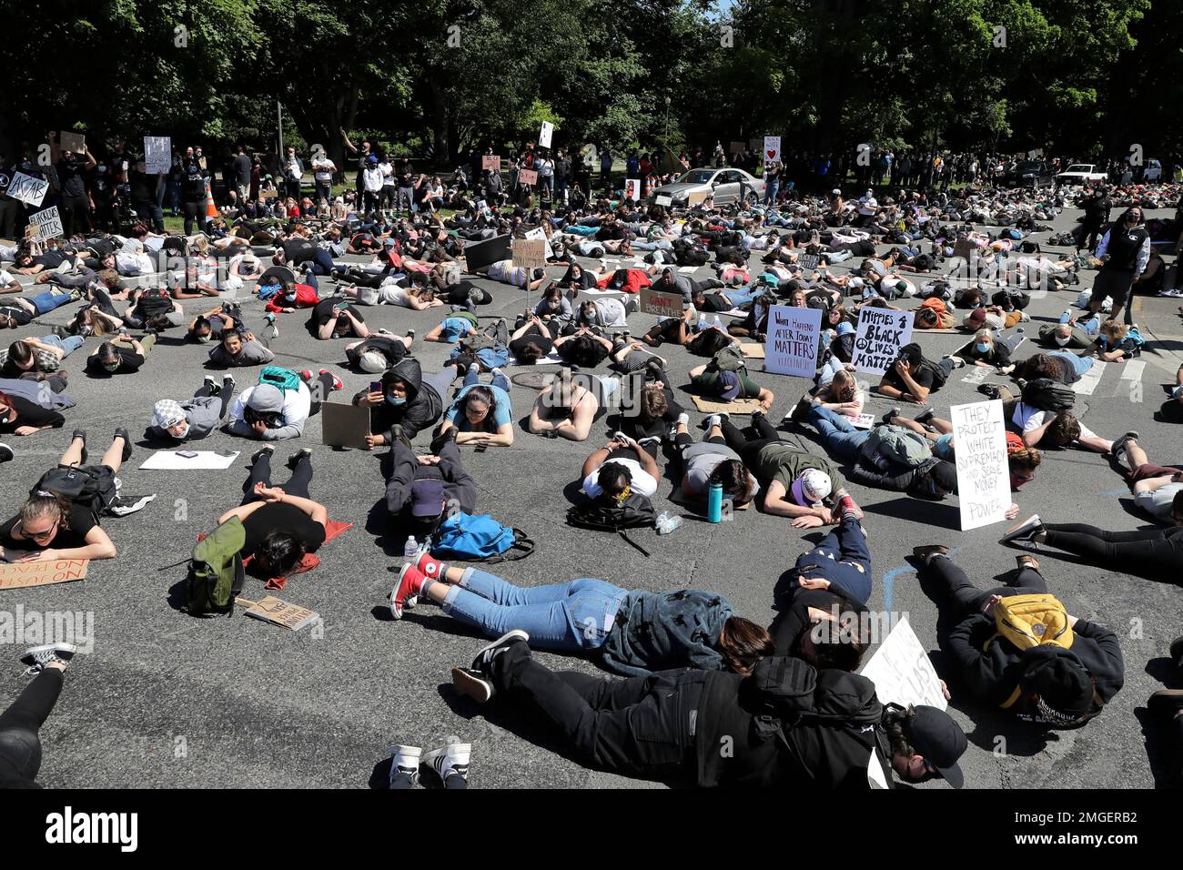 People block traffic as they lay face down on the street in an ...
