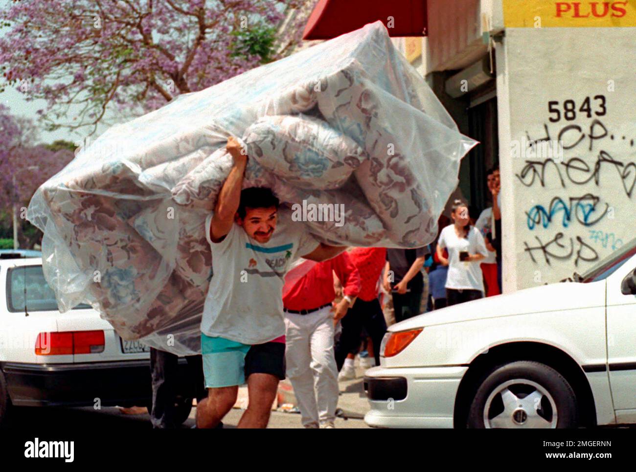 FILE - In this April 29, 1992 file photo, a man removes a couch from a ...