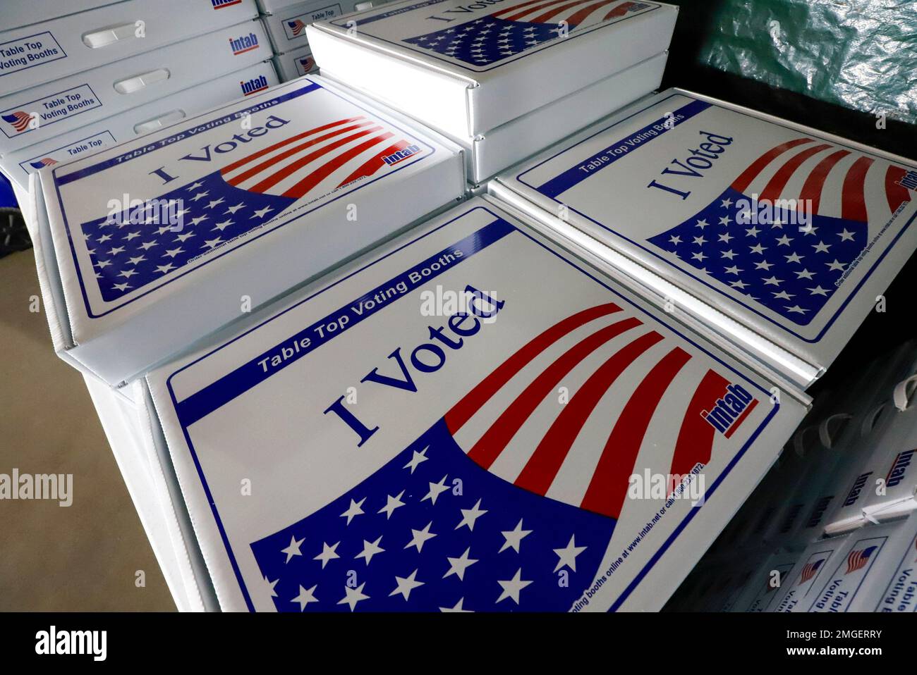 A stack of table top voting booths are stored for Tuesday's primary at ...