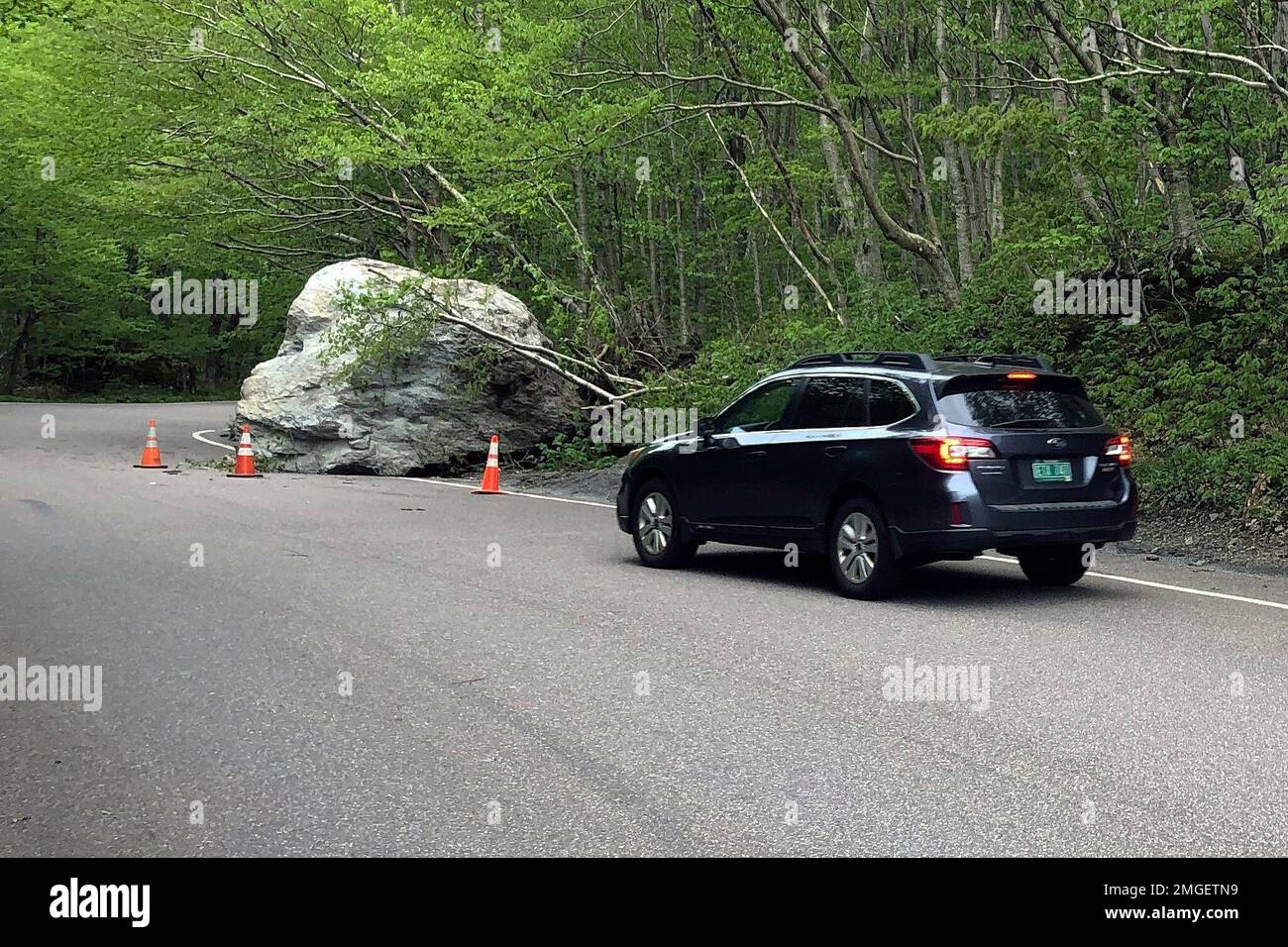 In this Sunday, May 31, 2020, photo, a car approaches a boulder in the ...