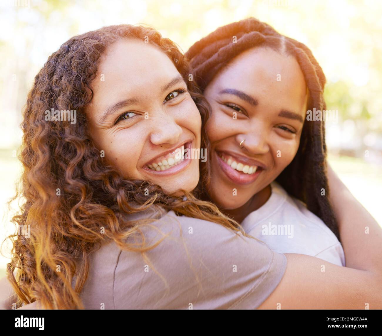 Young women and friends hug portrait for togetherness at park for ...