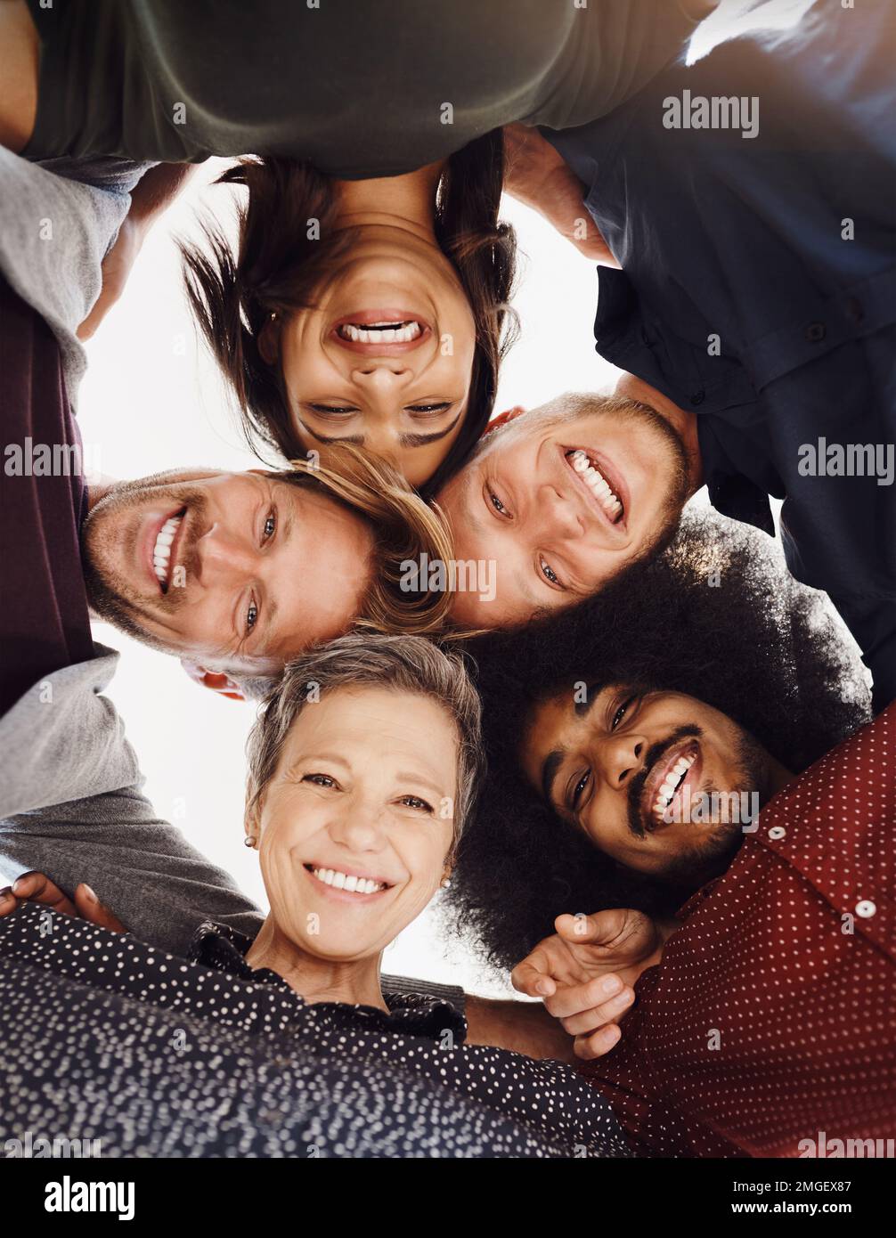 Huddled up and ready to take on the world. Low angle portrait of a team ...