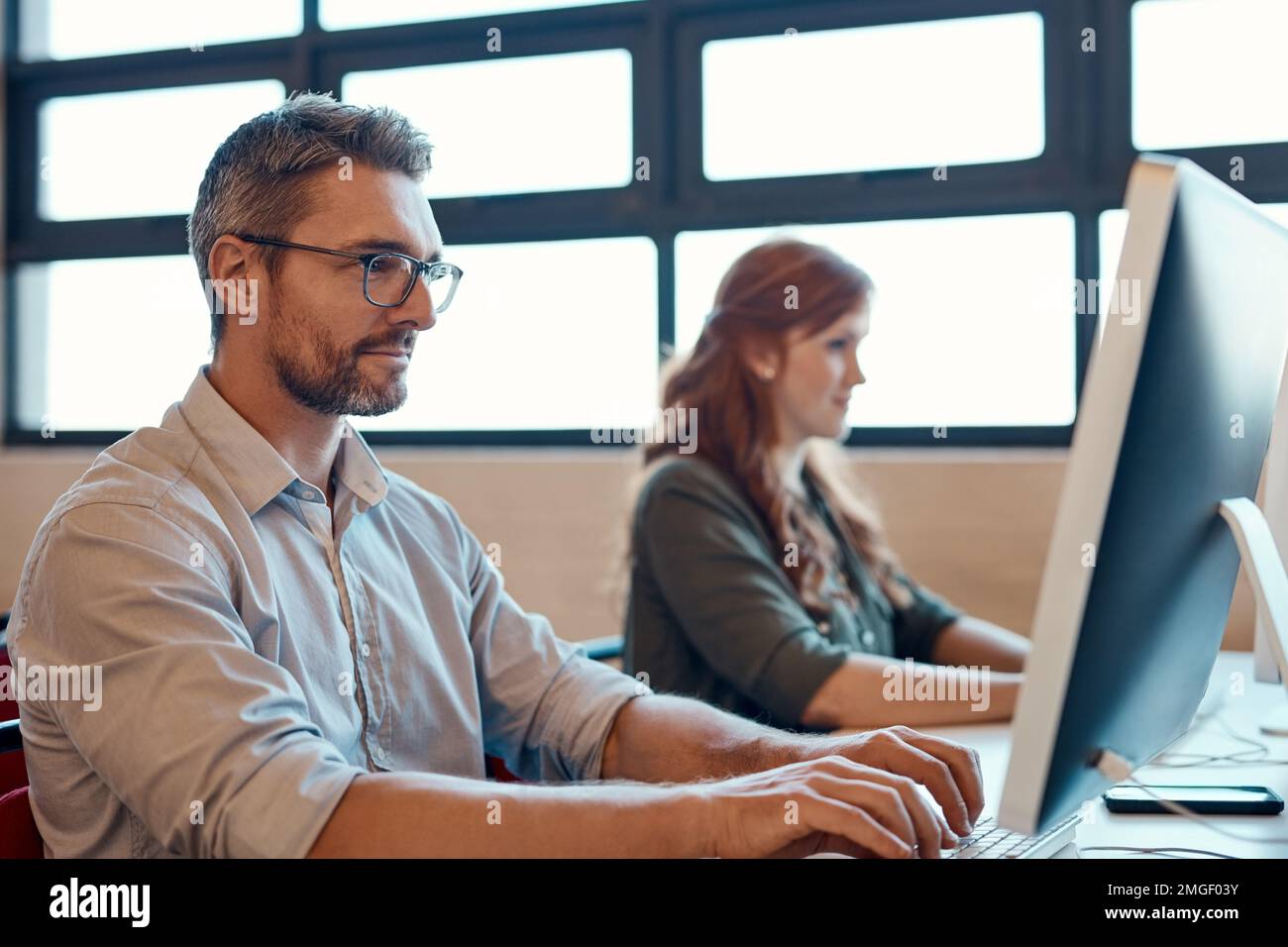 The focused team is a get it done team. a mature businessman and young ...