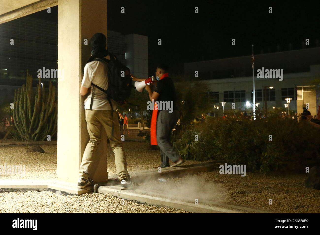 Protesters try to avoid rubber bullets deployed near Phoenix Police ...