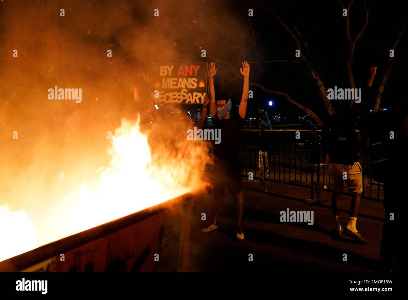 A fire burns in a dumpster as demonstrators protest the death of George ...