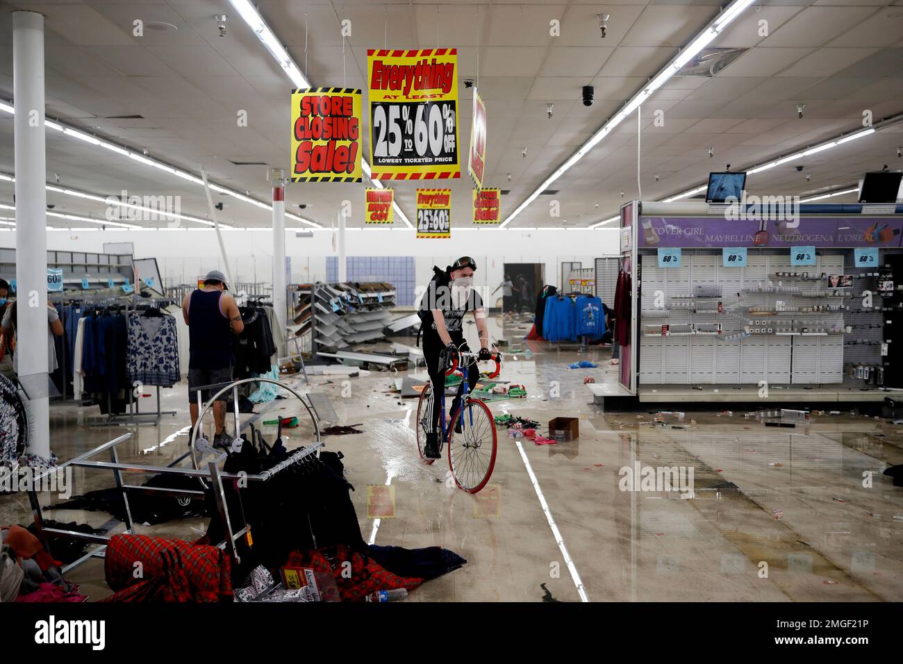 People browse and cruise through an emptied K-Mart Saturday, May 30 ...