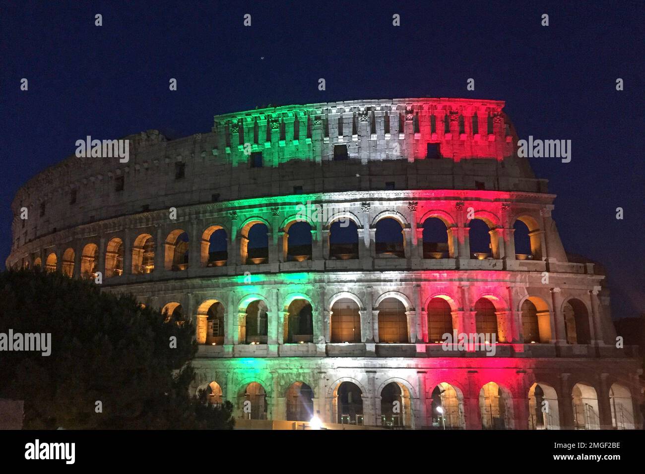 The ancient Colosseum is illuminated in the colors of the Italian flag ...
