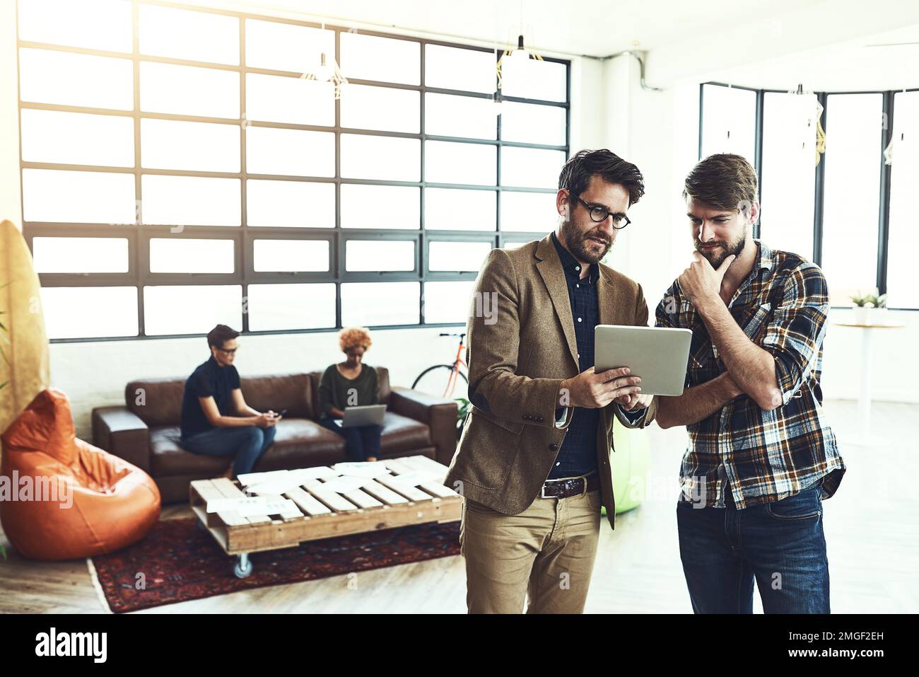 Find the right technology tools. two designers discussing something on ...