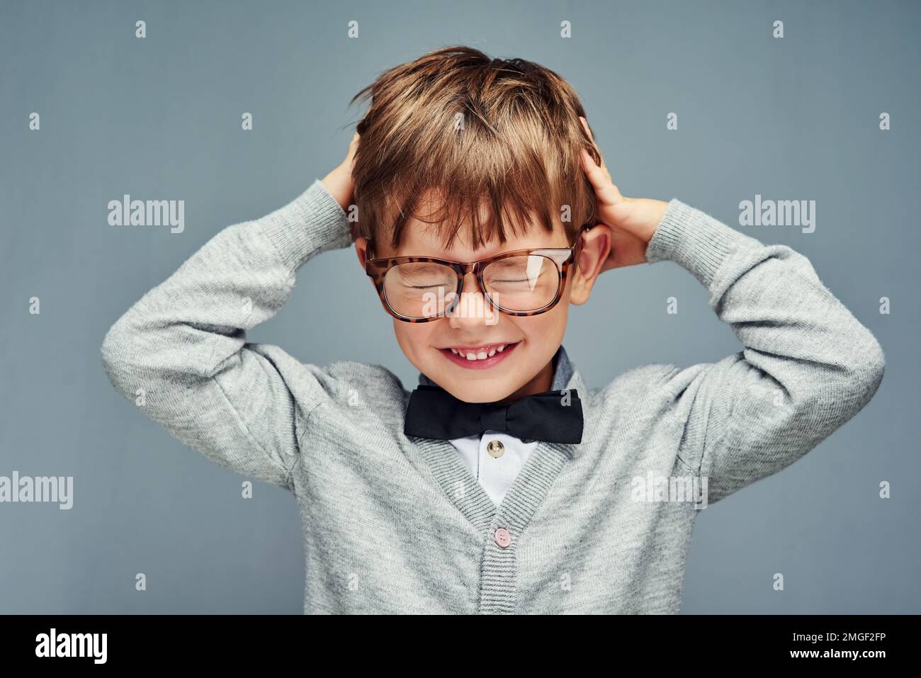 Knowledge overload. Studio portrait of an adorable little boy dressed ...