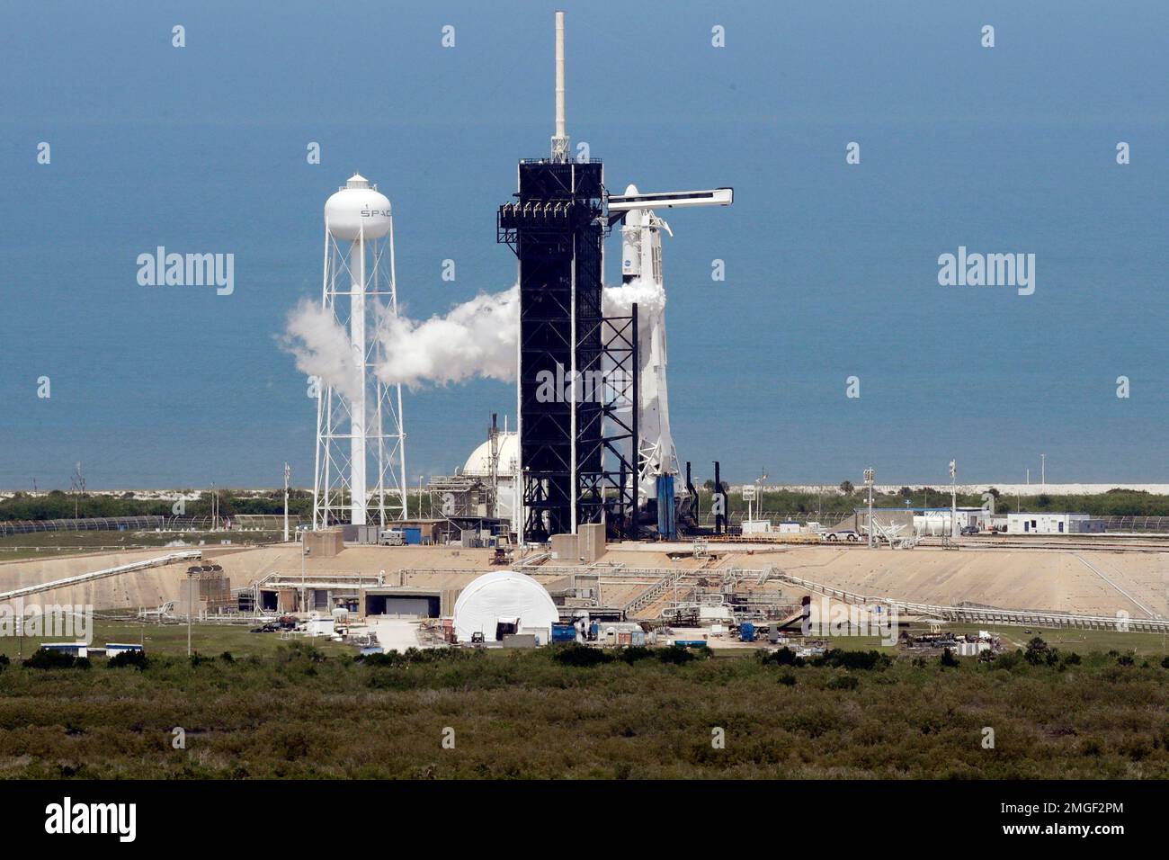 A SpaceX Falcon 9, with NASA astronauts Doug Hurley and Bob Behnken in ...