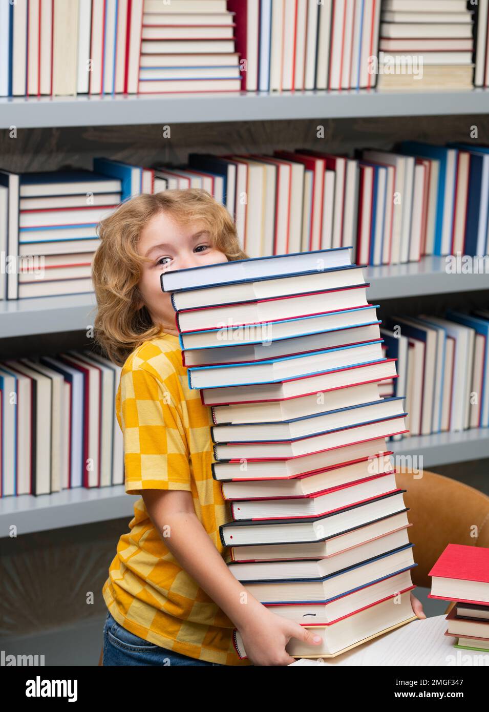 School bullying. School child studying in school library. Kid reading ...