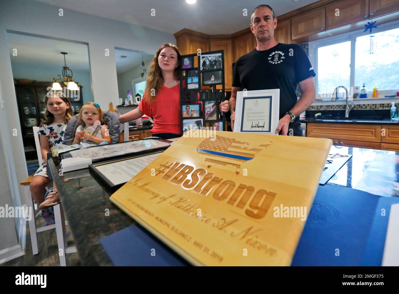 In this May 22, 2020, photo, Jason Nixon, right, holds a letter from ...