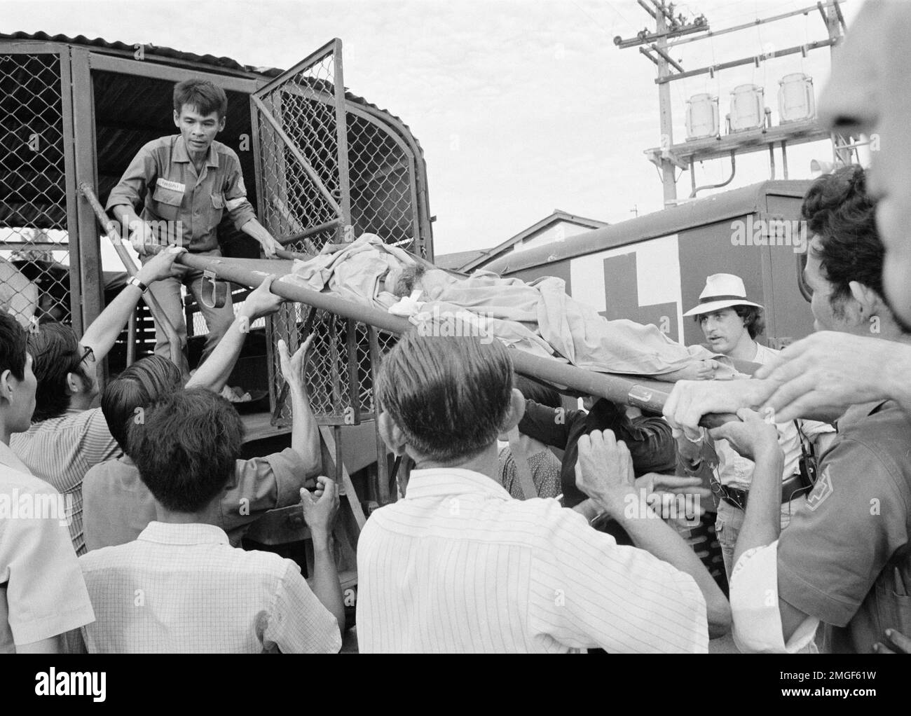 Victims of a C5A plane crash are lifted down off a truck at a Saigon ...