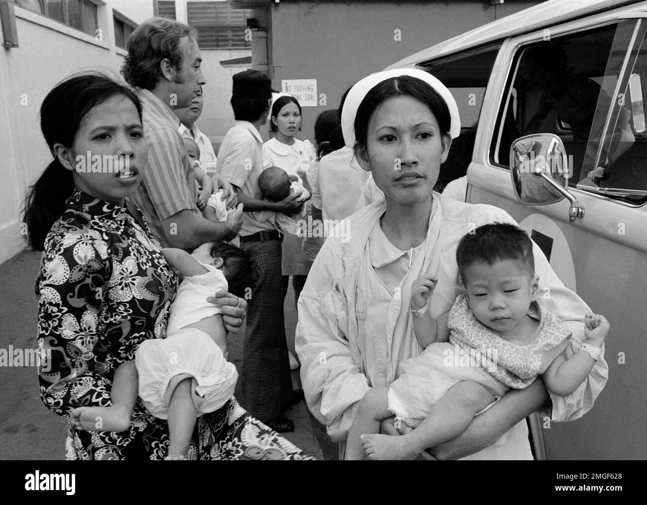 South Vietnamese infants are carried by nurses after arrival at Saigon ...