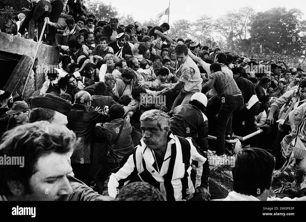 FILE - In this May 29, 1985 file photo soccer fans are crushed against ...