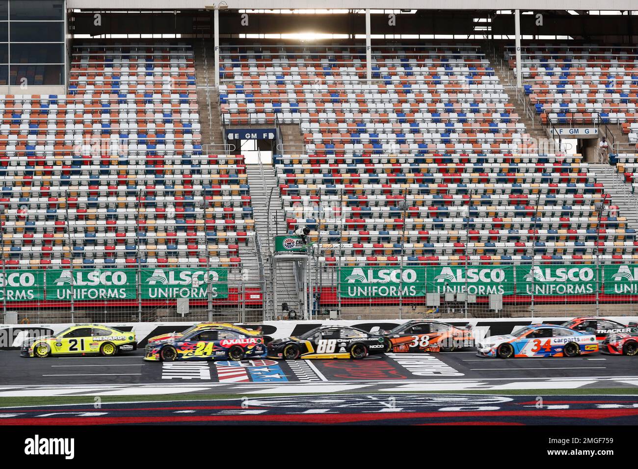 Cars pass empty stands during a NASCAR Cup Series auto race at ...