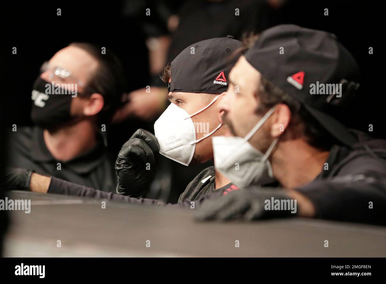 Fight team crew members watch during a UFC 249 mixed martial arts bout ...