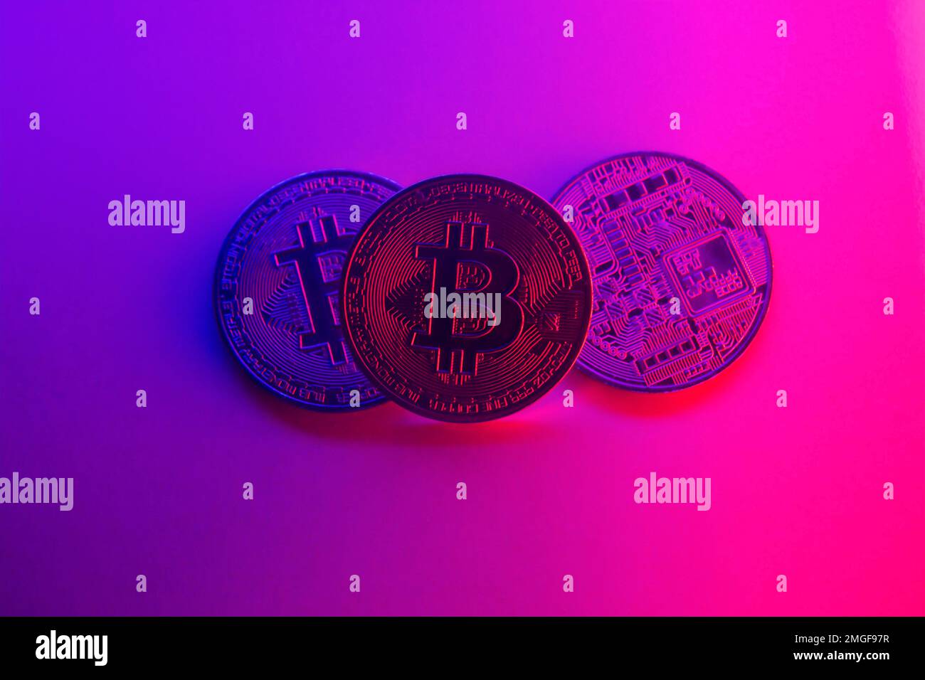 Bitcoin gold coin on neon color background. Virtual cryptocurrency ...