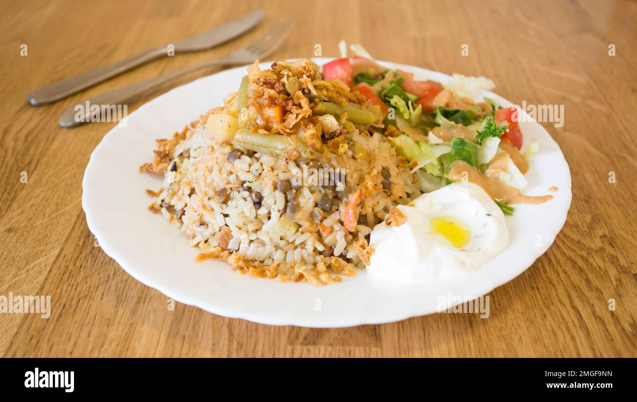 African combo plate with rice, fried cheese, grilled vegetables, peanut ...