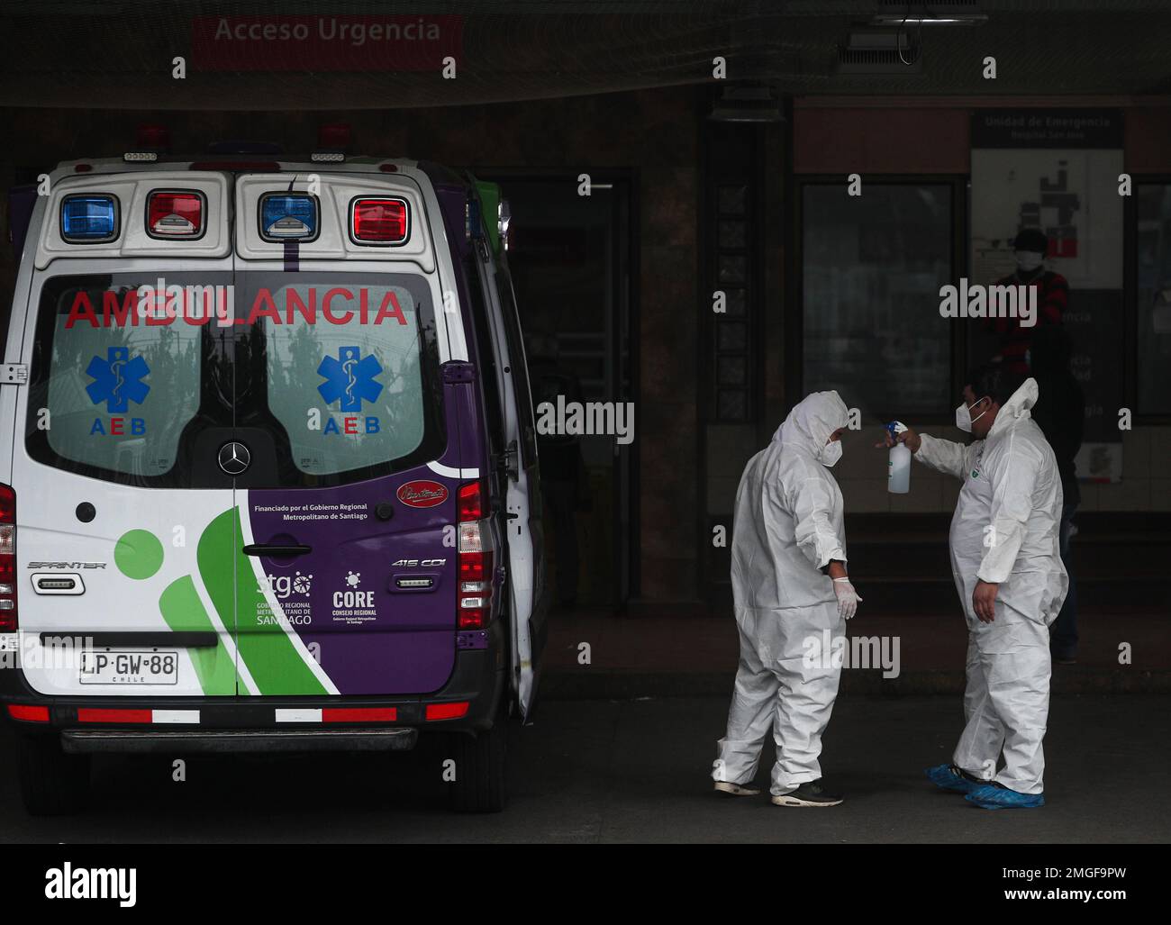 Ambulance workers take turns spraying each other with disinfectant ...
