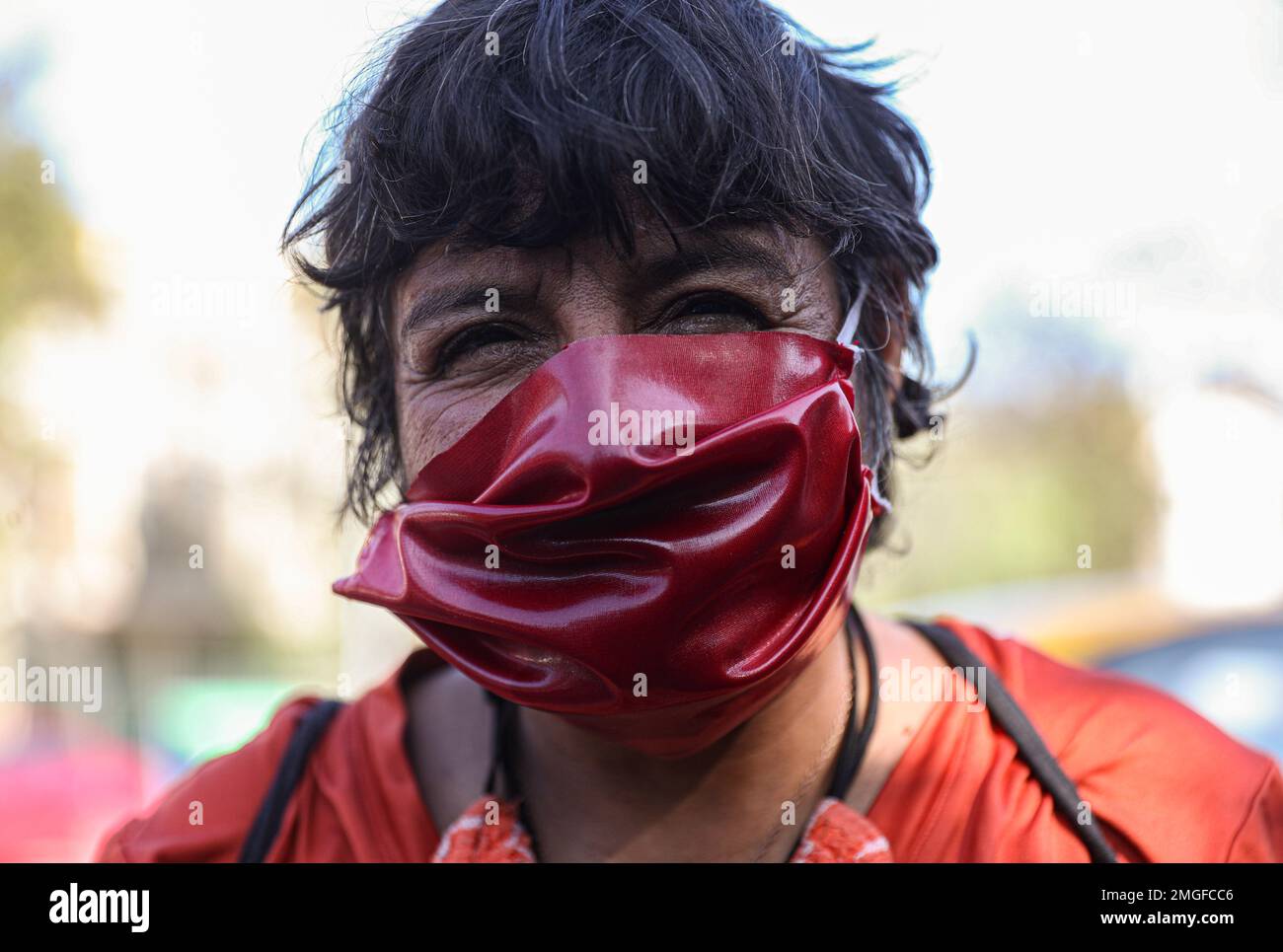 A homeless woman wearing a makeshift protective face mask as a ...