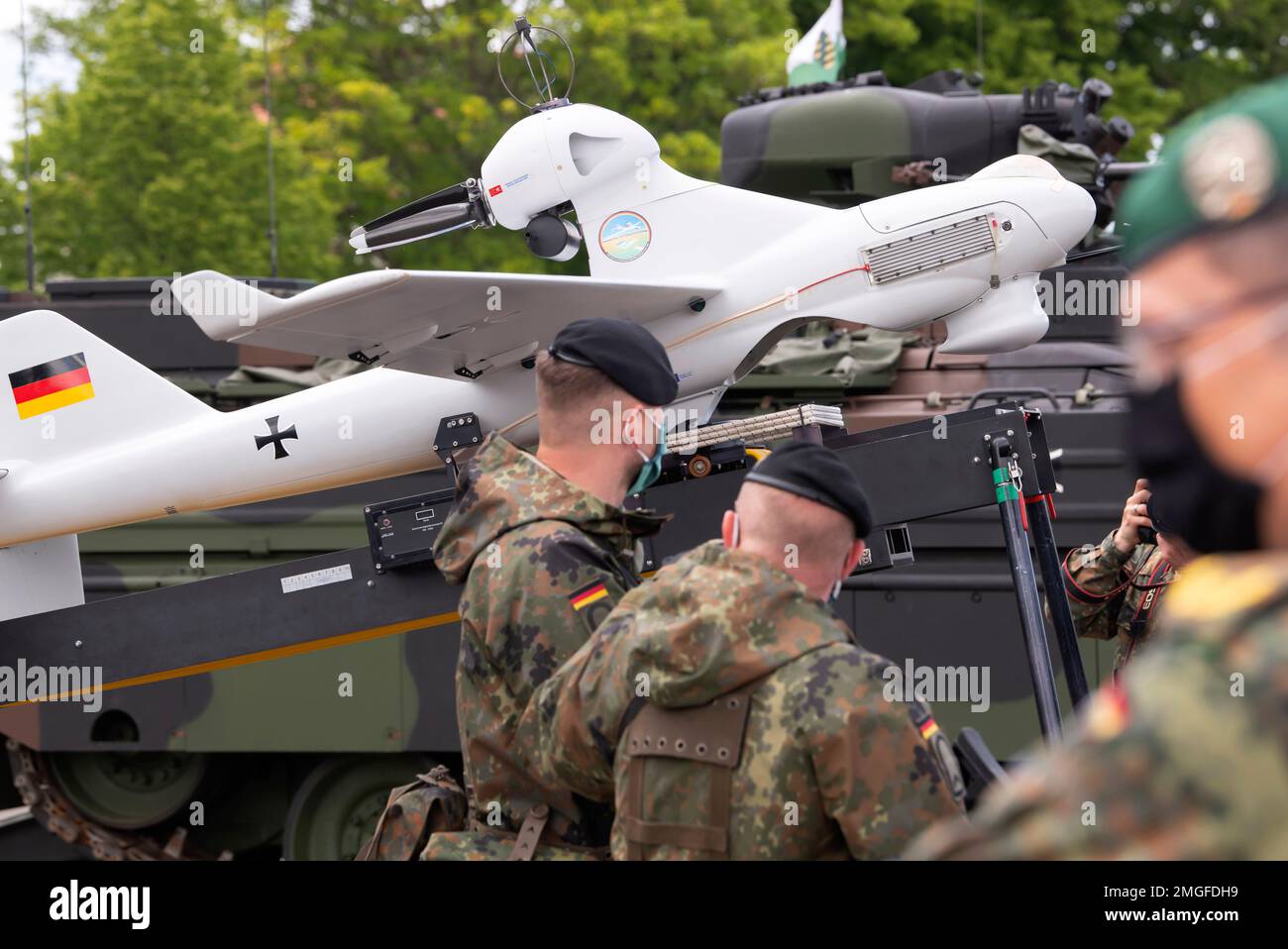 Soldiers of the German Federal Armed Forces Bundeswehr stand beside the ...