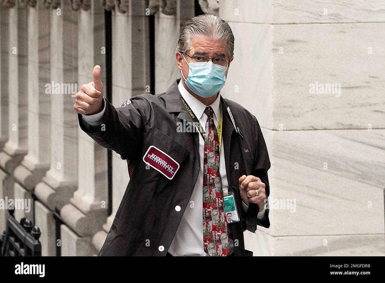 Trader Daniel Krieger signals a thumbs-up as he arrives at the New York ...