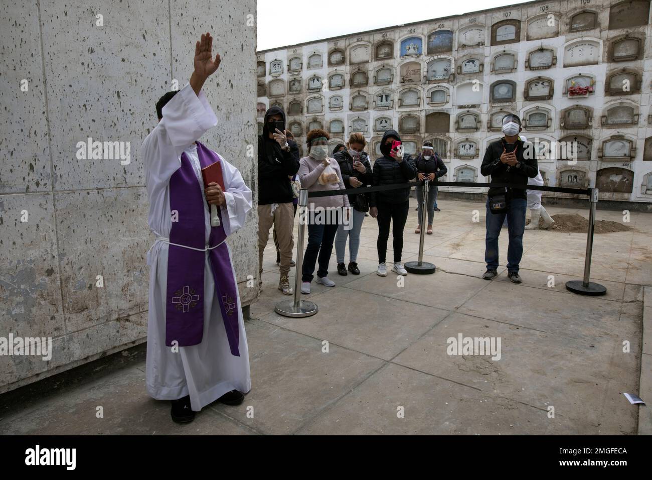 A Catholic priest prays with relatives of Elsa Francisca Sacramento ...
