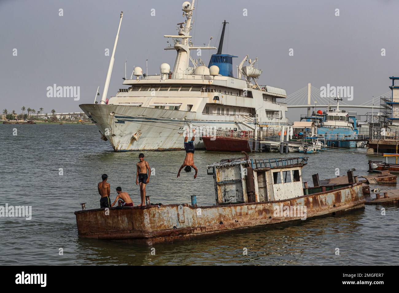 People swim in the Shatt al-Arab waterway to beat the heat, during Eid ...