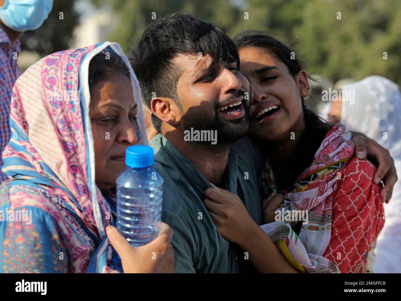 Family members and relatives of Simon Eric, who died in the crash of a ...