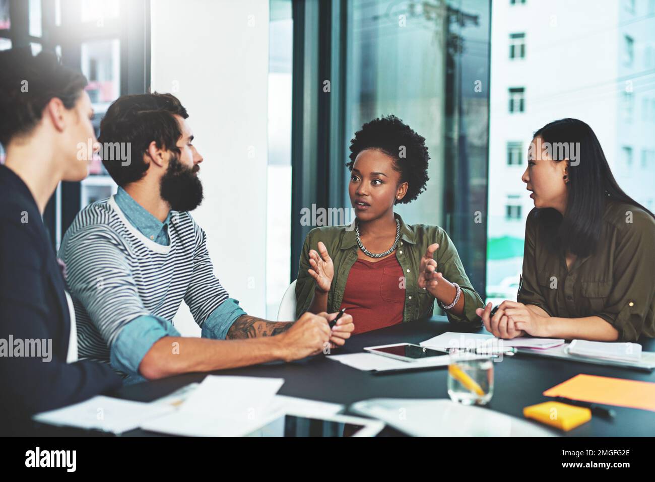 Decision-making is a team effort. a group of designers having a ...